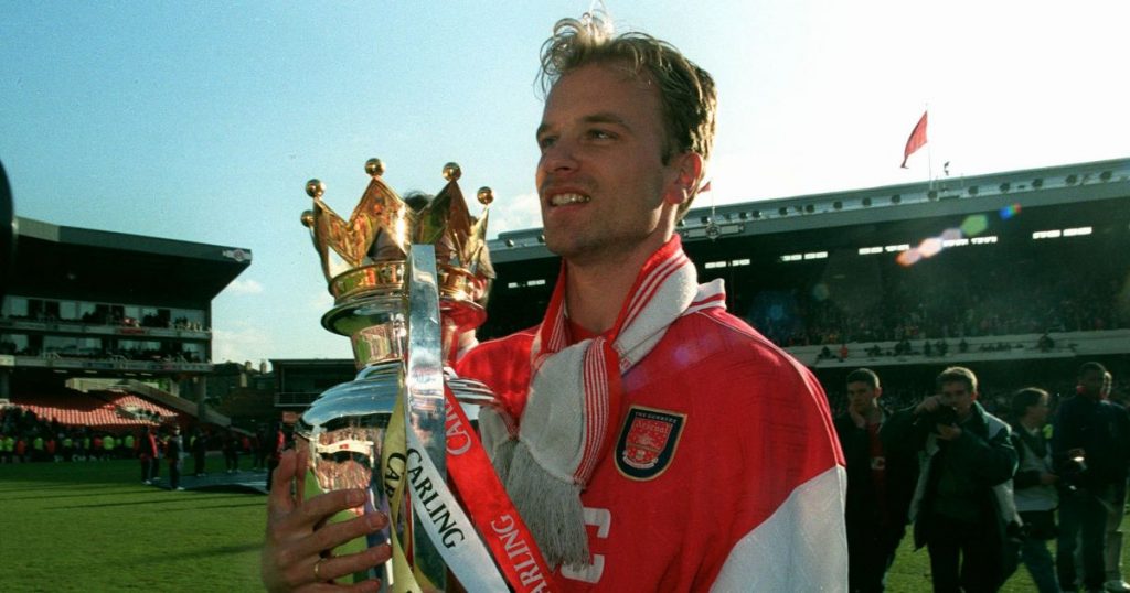 Dennis Bergkamp hugs the Premier League trophy at Highbury Stadium ...